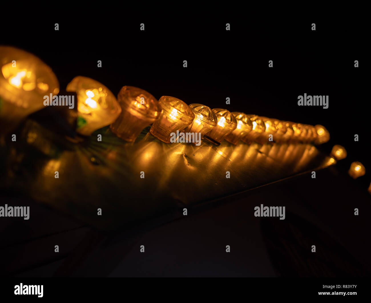 golden light chain in front of a dark background Stock Photo - Alamy