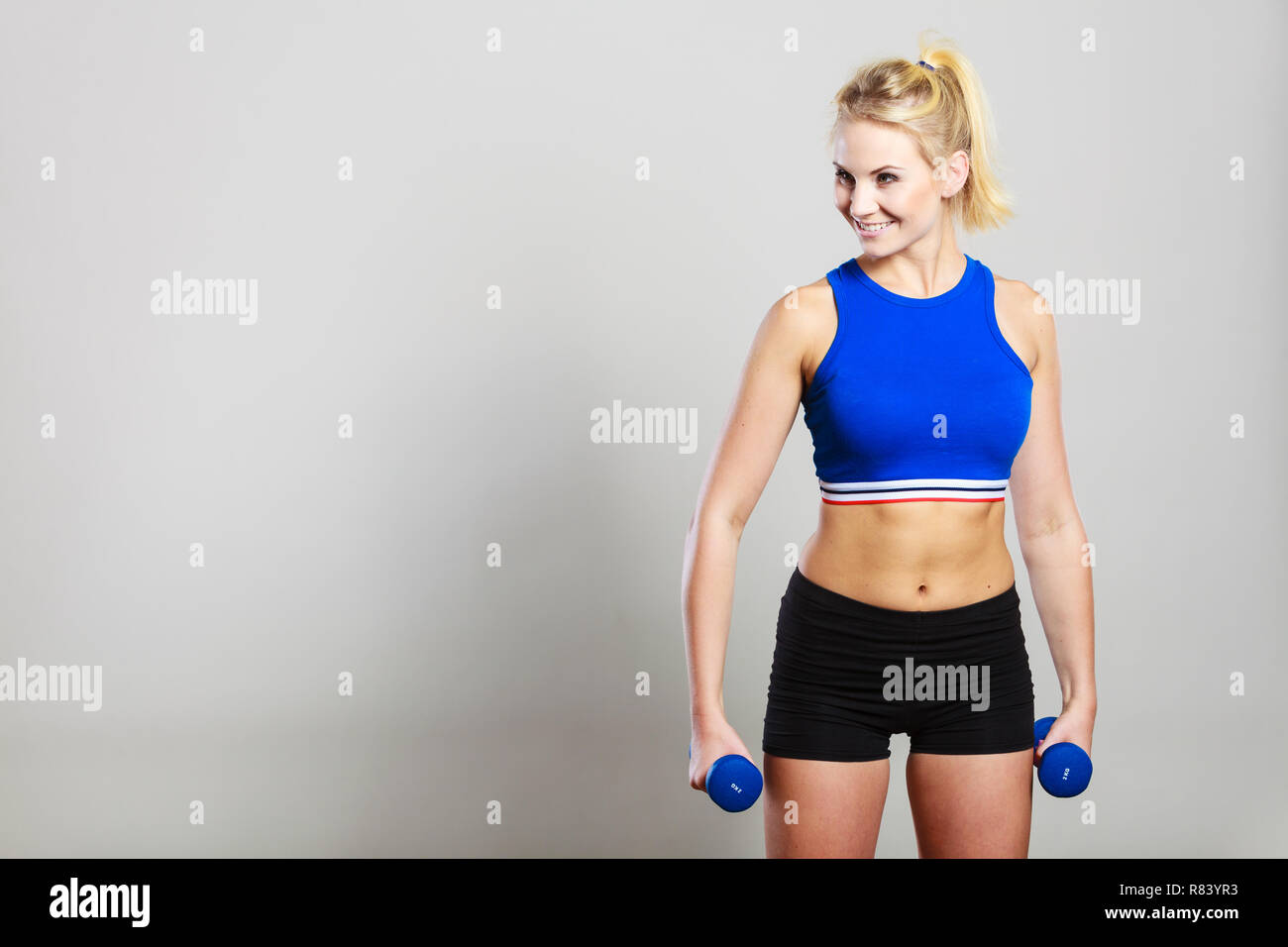 Sporty woman lifting light dumbbells weights. Fit girl exercising ...