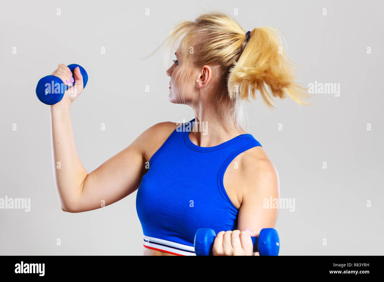 Sporty woman lifting light dumbbells weights. Fit girl exercising ...