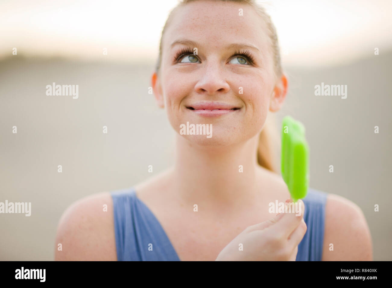 Woman eating flavored ice Stock Photo - Alamy