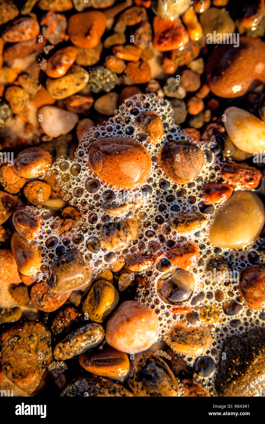 pebbles and spray of the surf Stock Photo - Alamy
