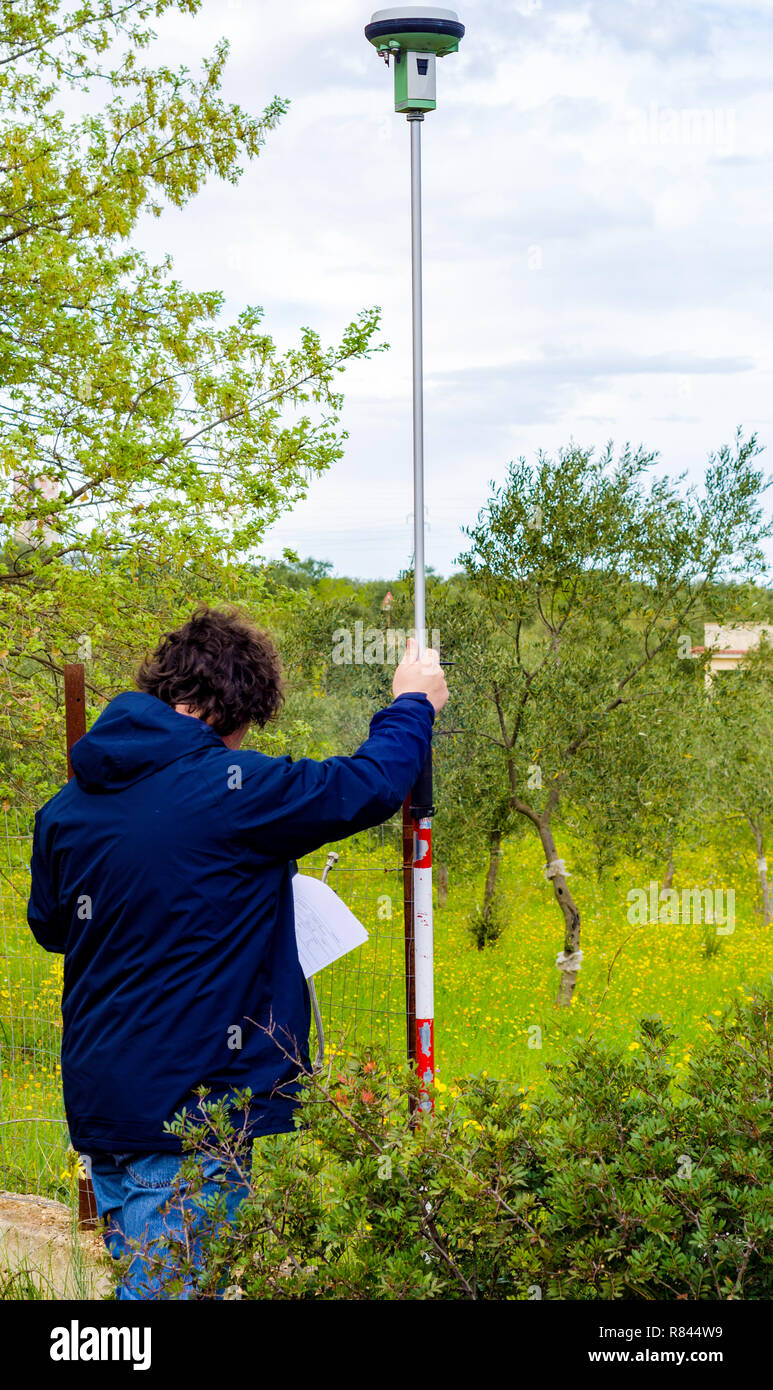 Professional land surveyor measures ground control point using a GNSS ...