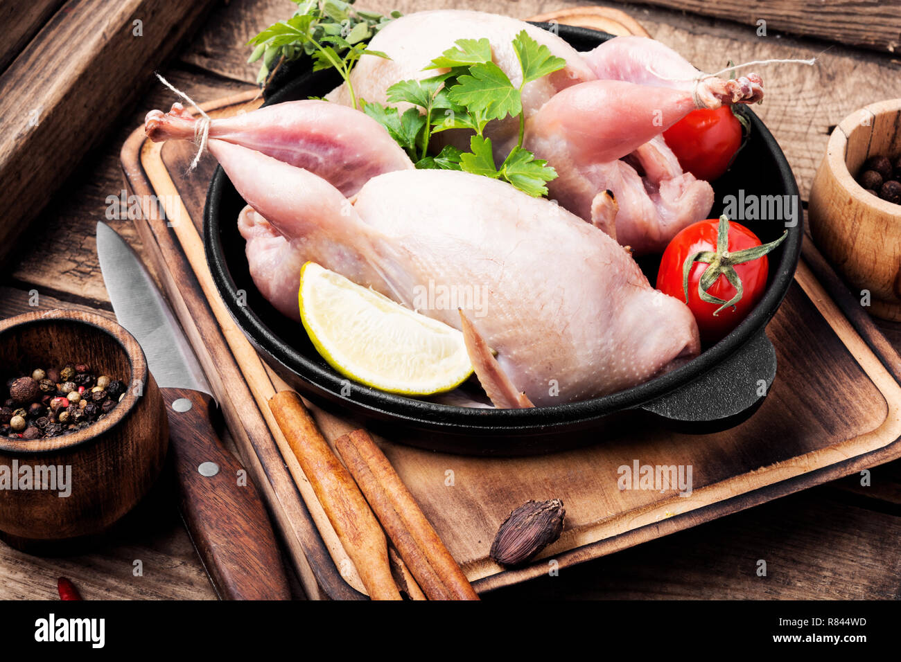 Fresh raw quail on a kitchen board and ingredients.Quail meat Stock ...
