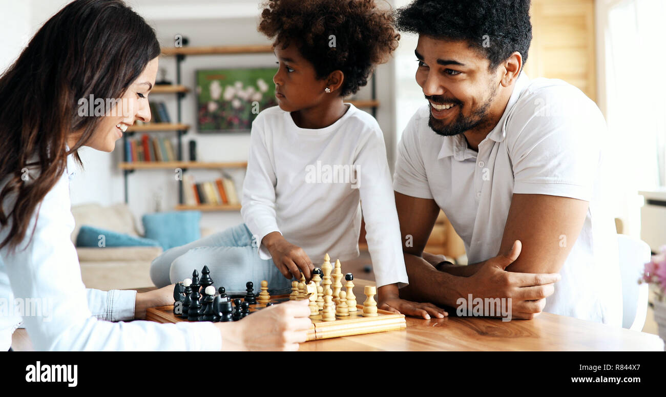 Happy family playing chess together at home Stock Photo - Alamy