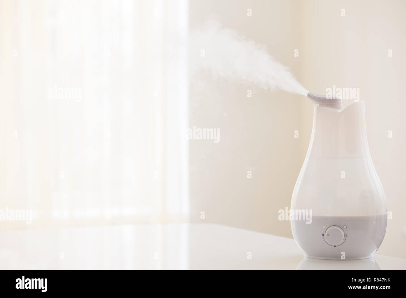 Humidifier spreading steam into the living room Stock Photo - Alamy