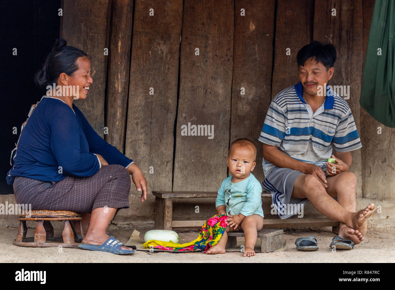 Thakhek, Laos - April 20, 2018: Local lao family sitting in front of ...