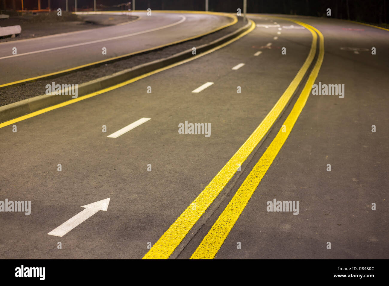 Wide bright yellow street marking sign line along modern wide smooth ...