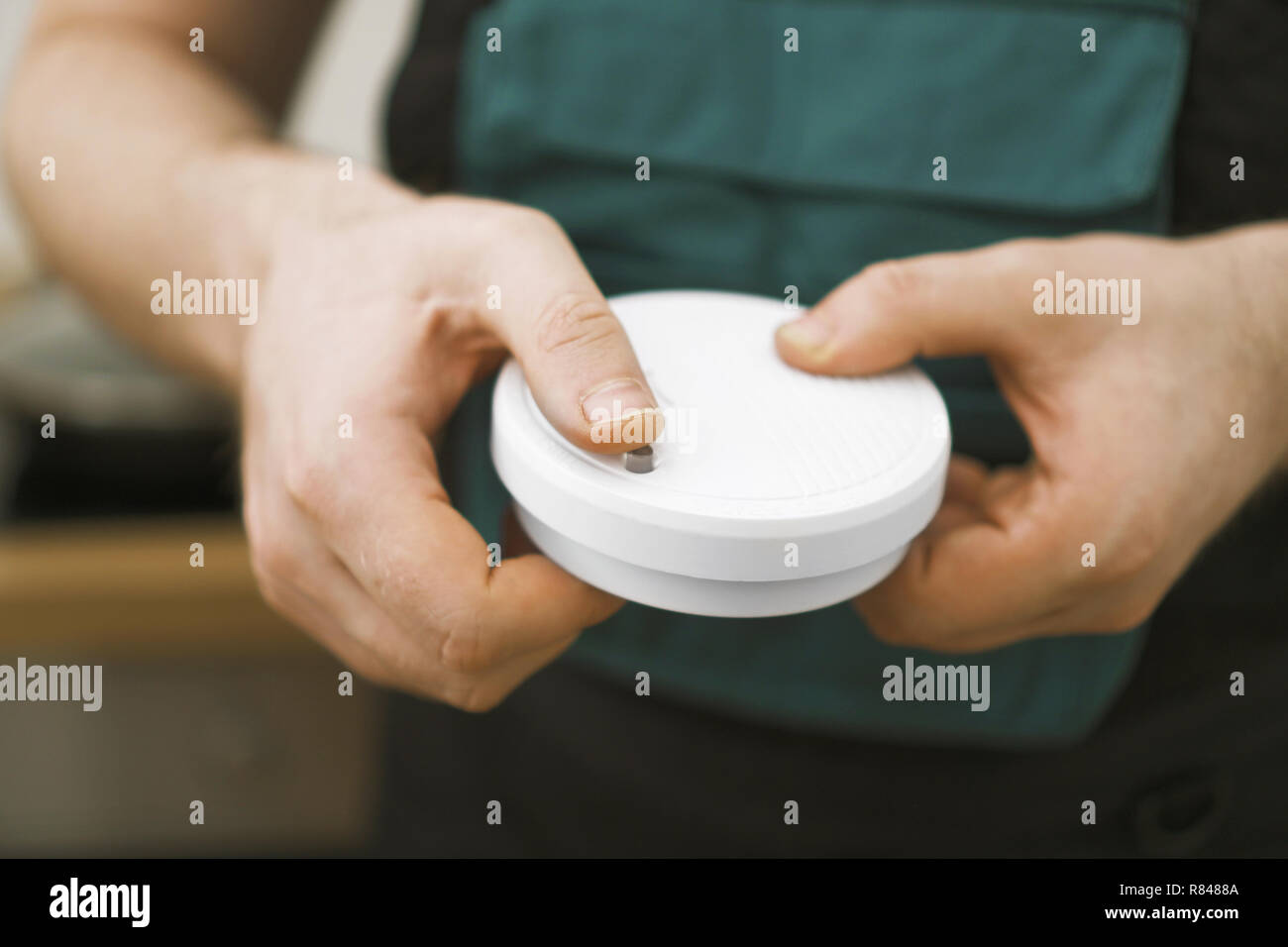 Man testing smoke detector before use Stock Photo - Alamy