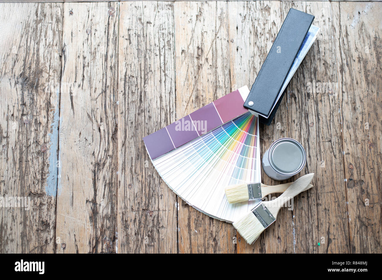 Painter and decorator work table with color swatches and paint brushes ...