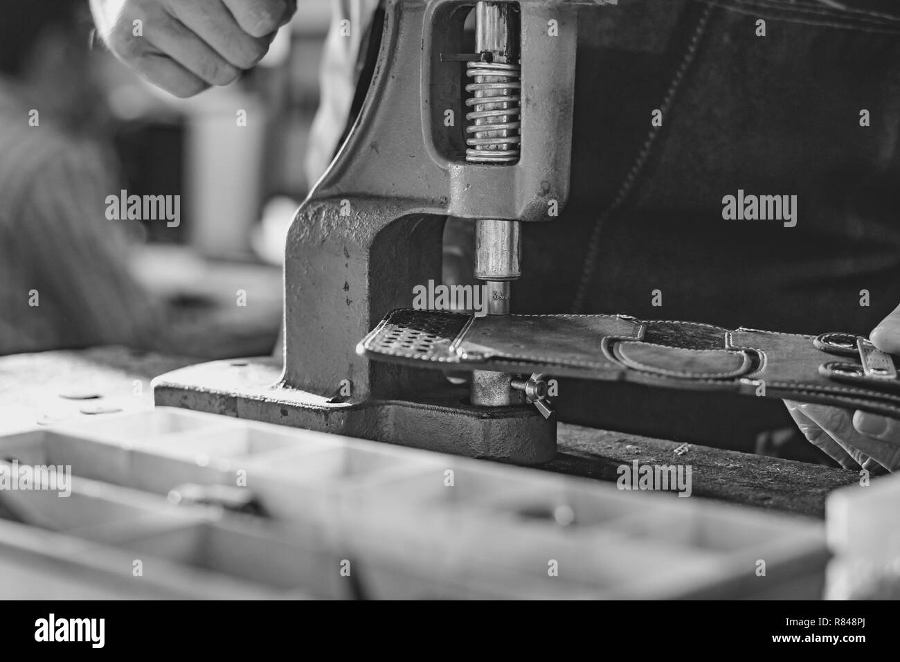 Man works in carpentry workshop. He fixes wooden handle in vice ...
