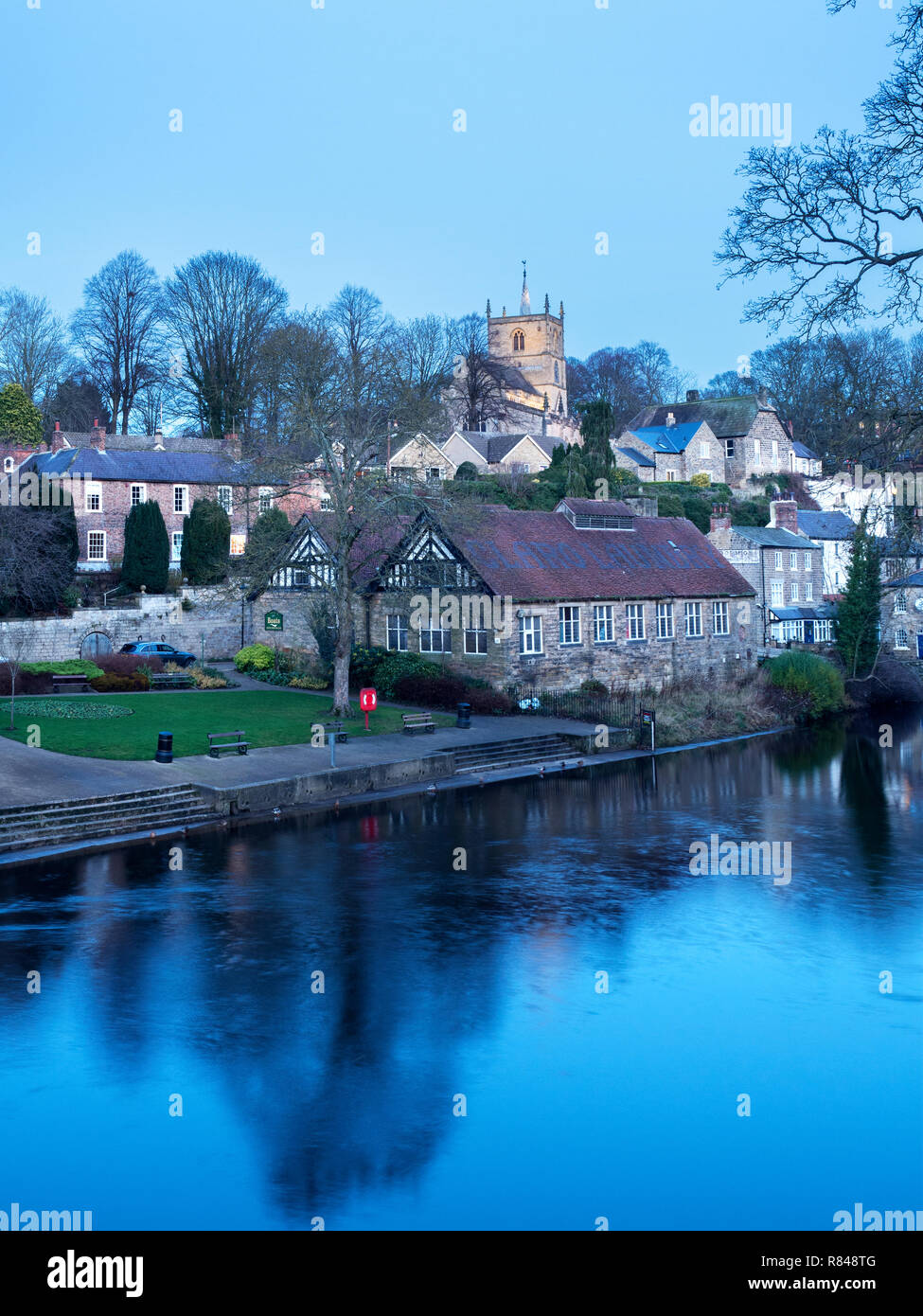 St Johns Church and buildings along the River Nidd at dusk ...