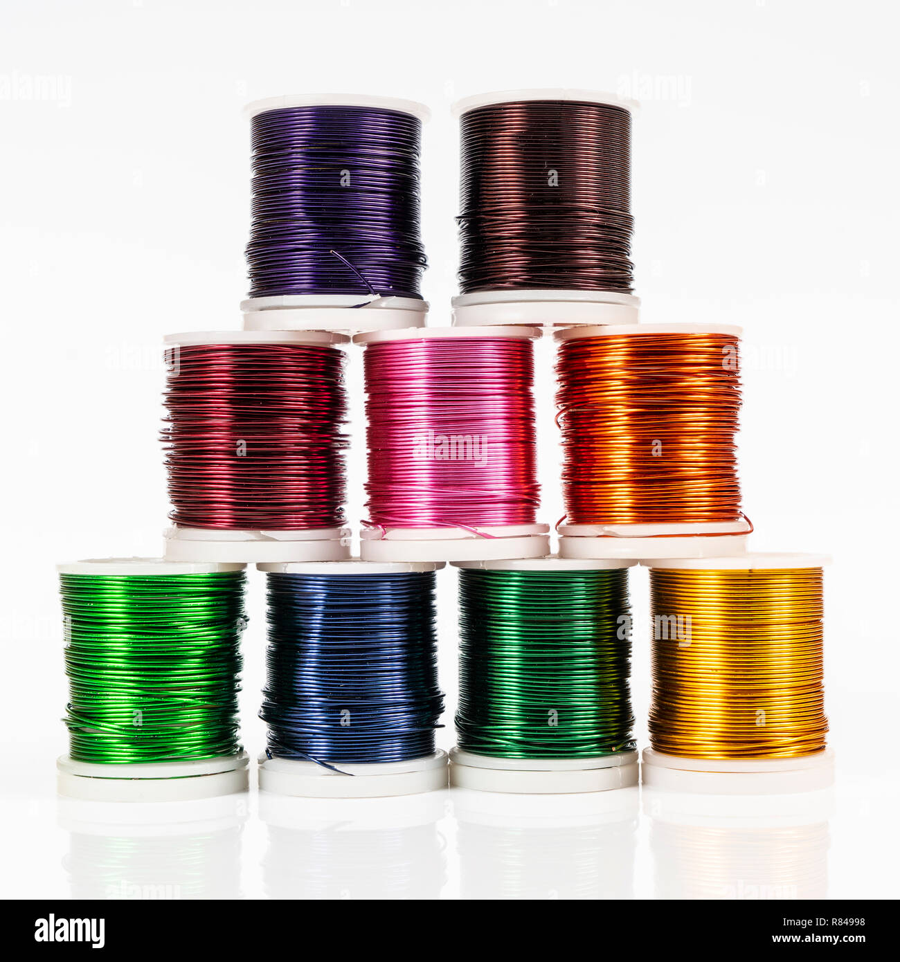 Some spools of colored metallic thread Stock Photo - Alamy