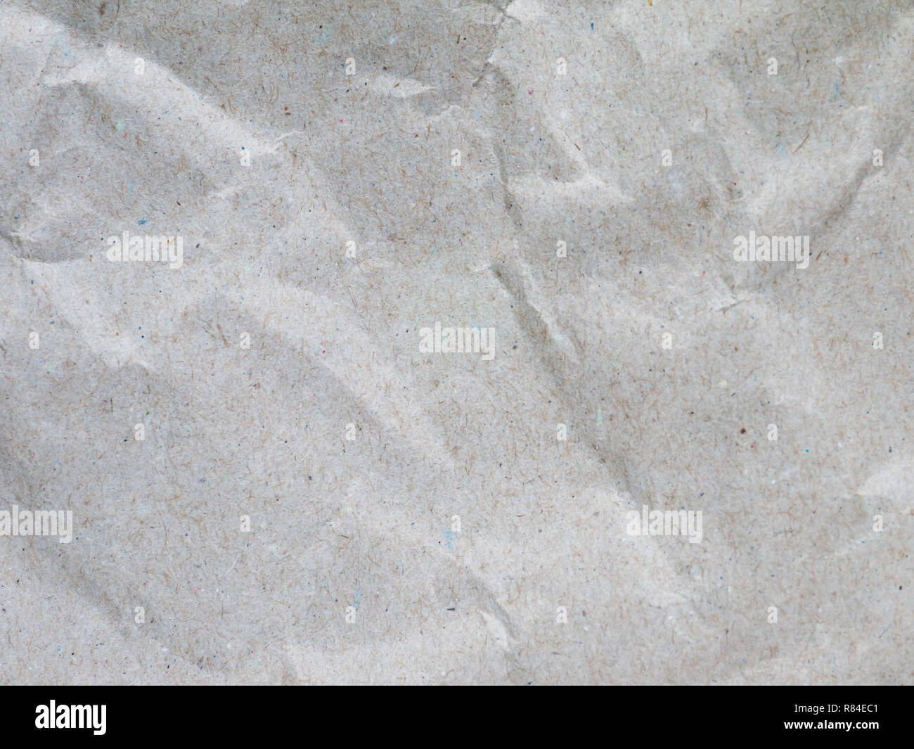 Crumpled recycled gray spotted packing paper with inclusions texture ...