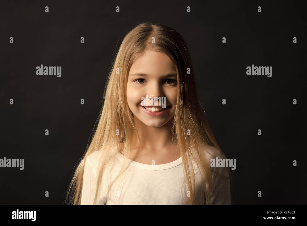 Kid model smiling with long healthy hair. Girl with smile on cute face ...
