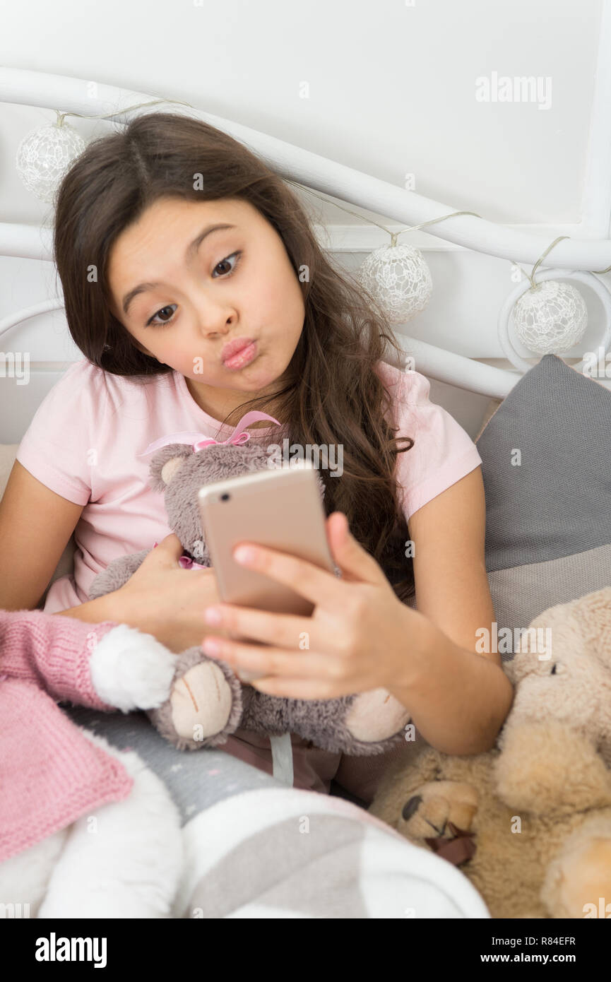 Happy childhood. Girl with smartphone use modern technology. Selfie ...
