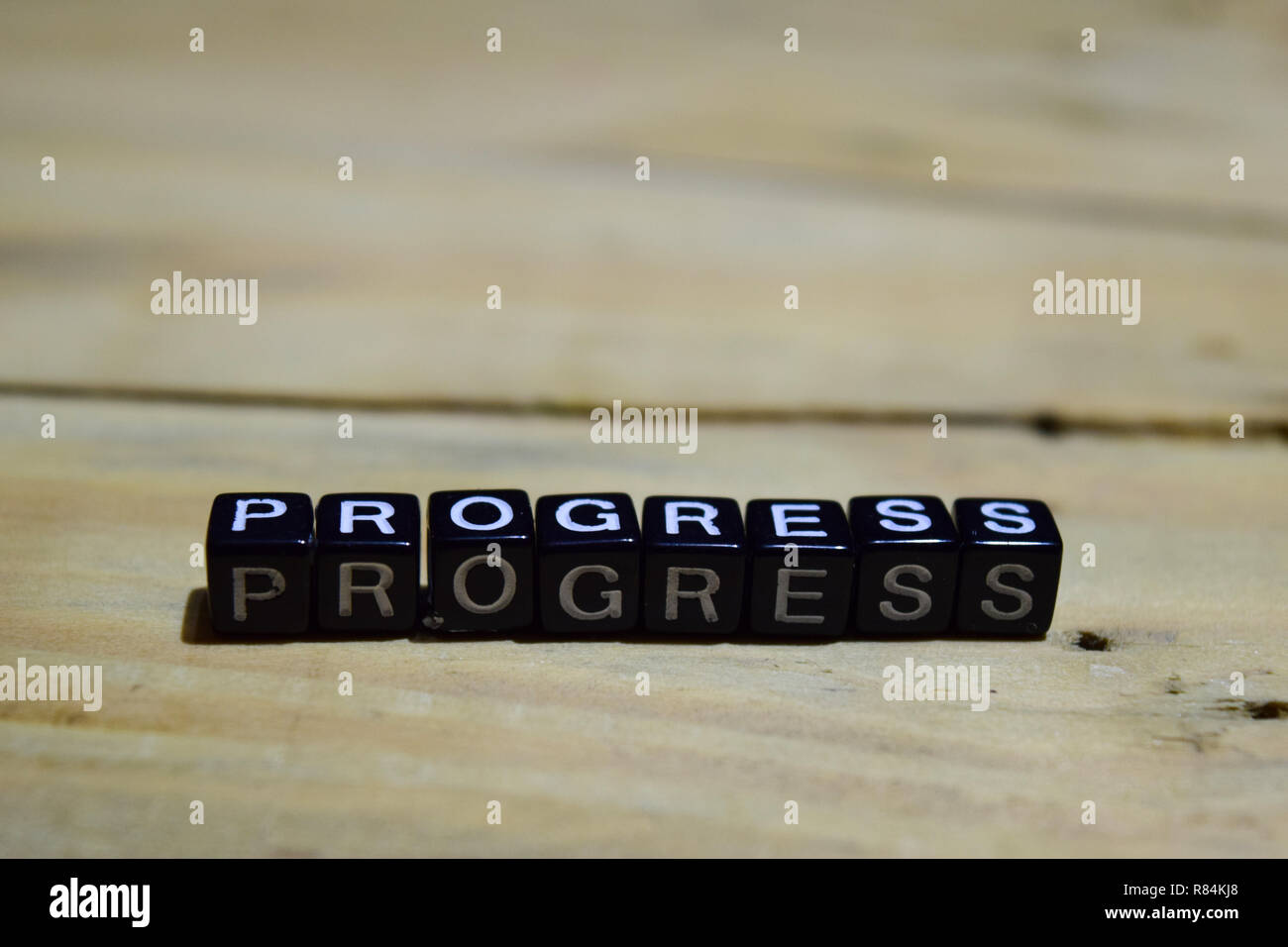 Progress message written on wooden blocks. education and motivation ...