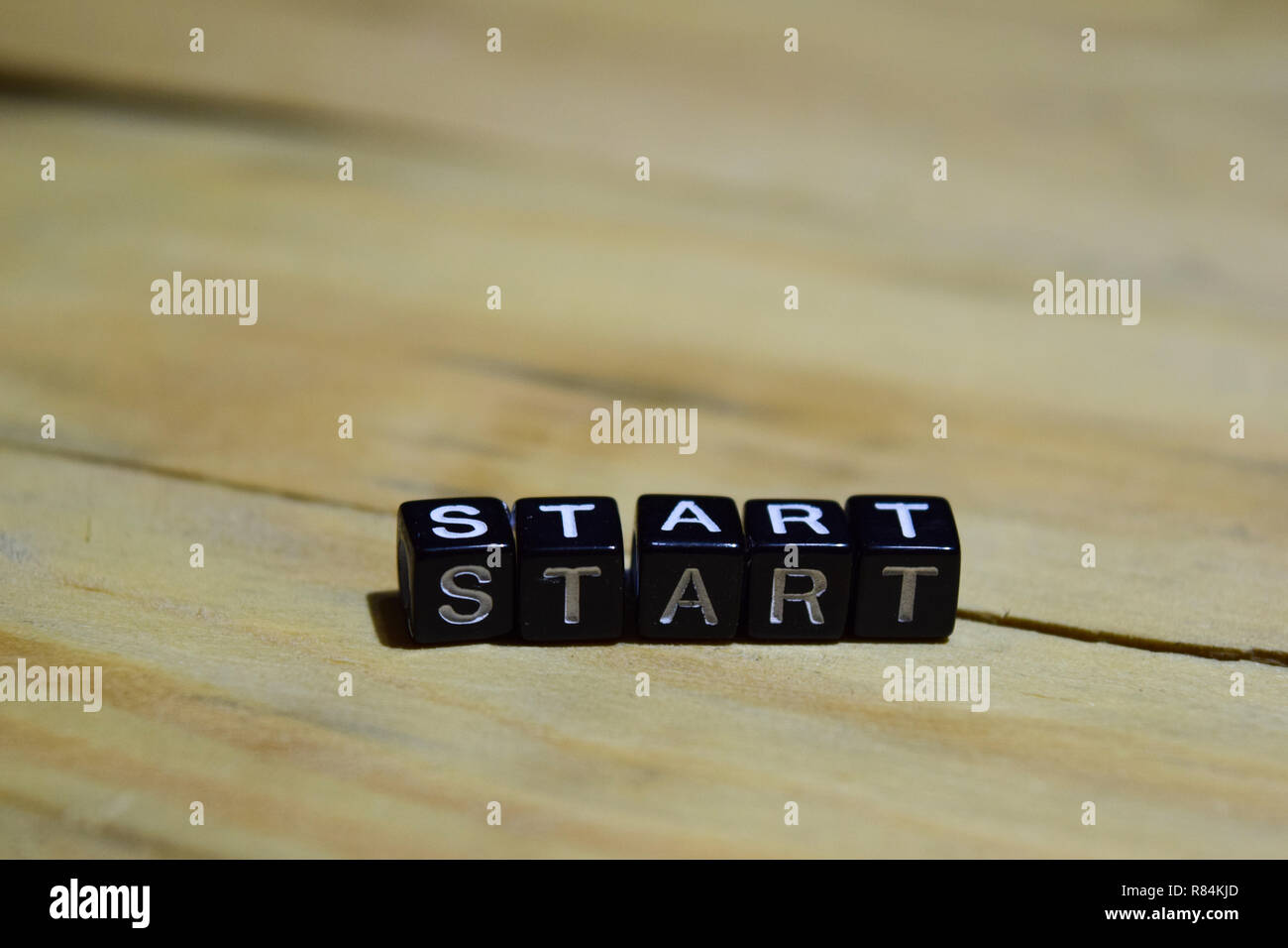 Start message written on wooden blocks. education and motivation ...