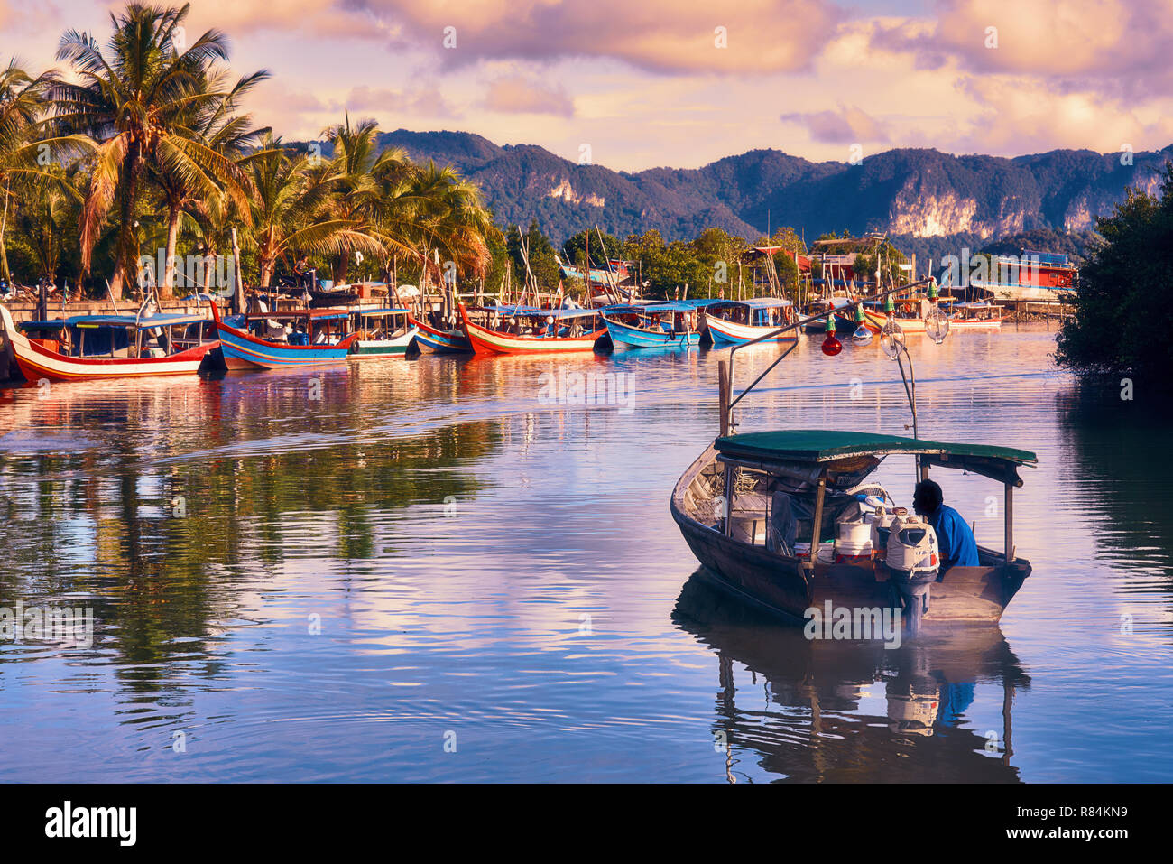 A local fisherman goes out on a boat from boats park to the sea for ...