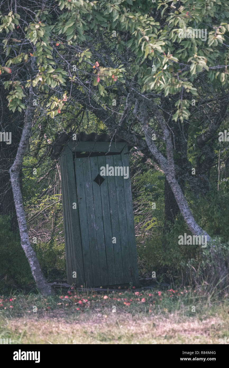 old wooden countryside toilet house with heart shaped hole in the door ...