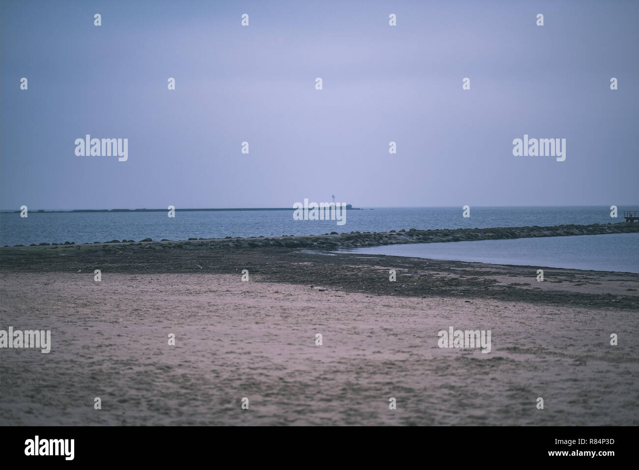 empty sea beach in autumn with mist and cool tones in empty sand ...
