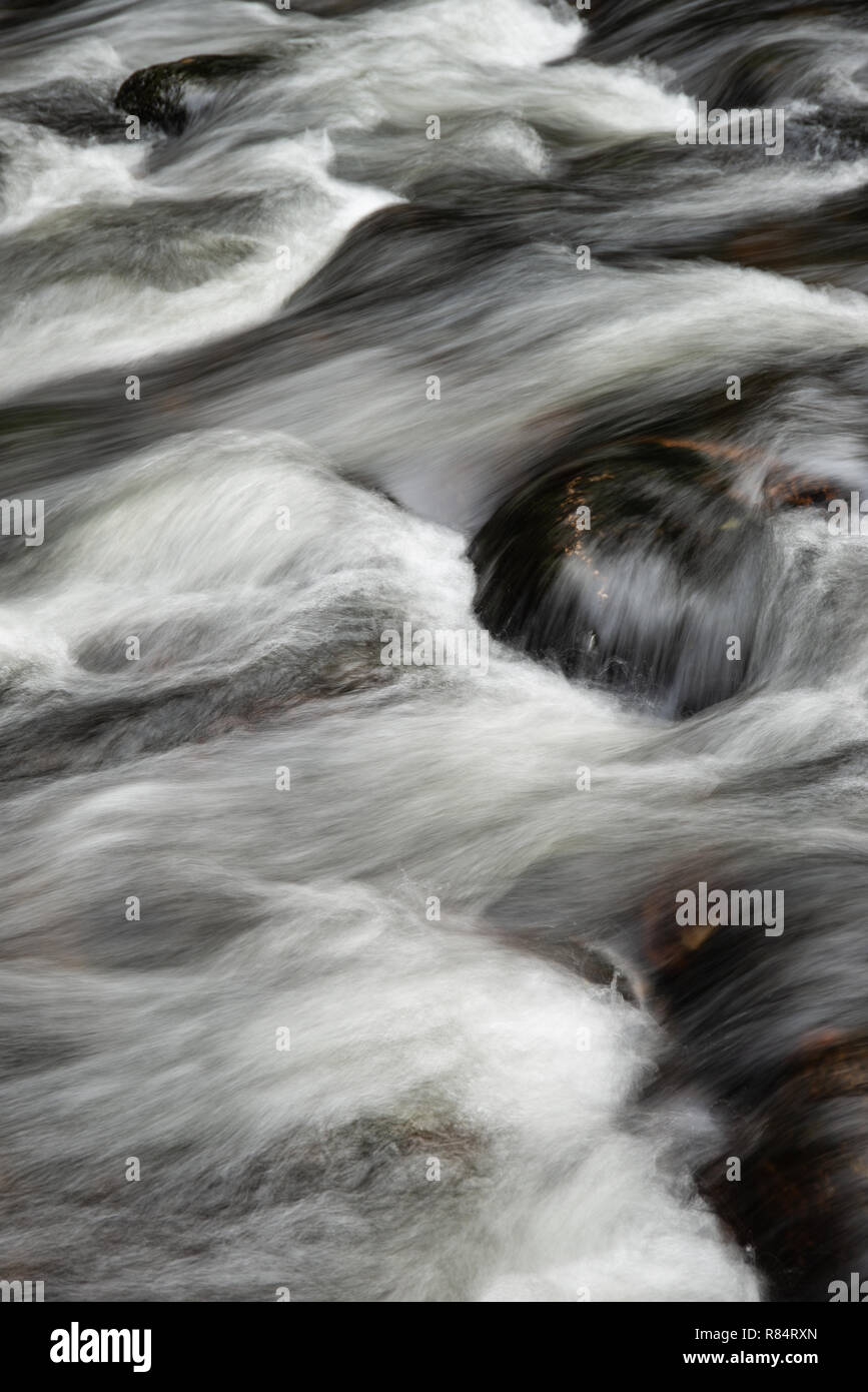 Detail landscape image of river flowing over rocks with long exposure ...