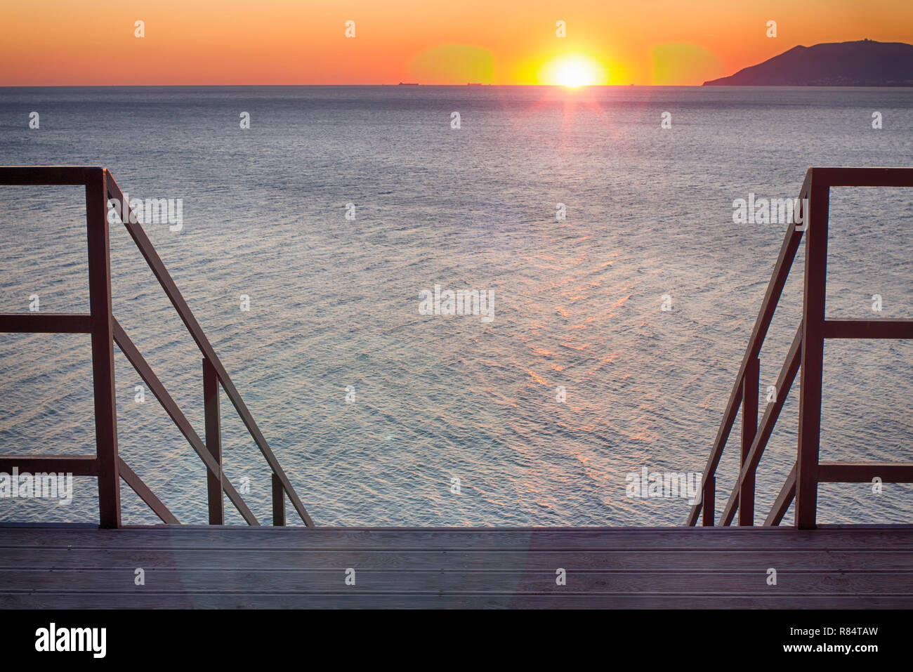 Stairs leading into the sunset. Seascape, lens flare 35 mm Stock Photo ...
