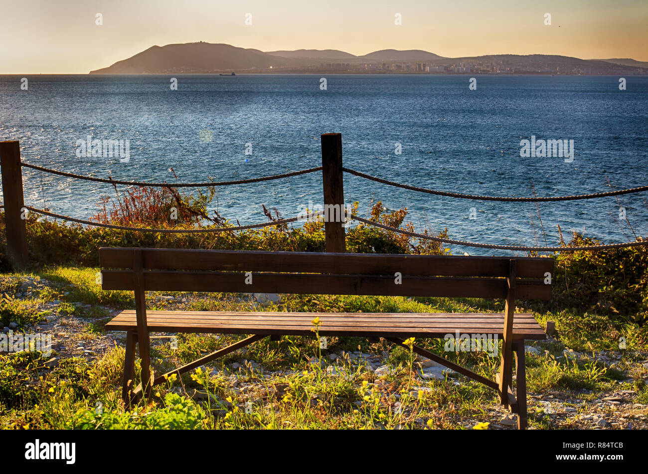 Bench by the sea. Waiting for the sunset on the cliff. A place of ...