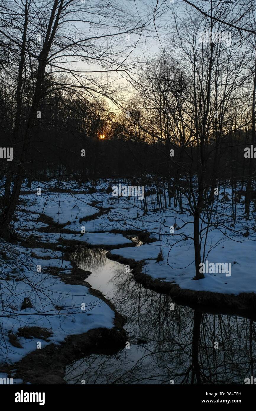 The sun takes one last peek at the meandering stream running through ...