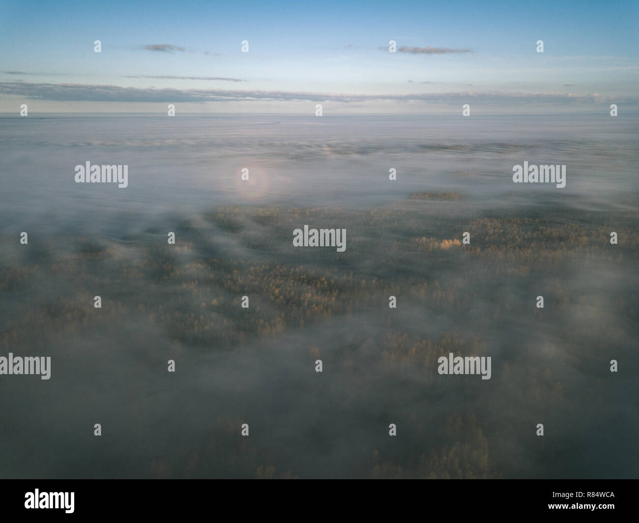 drone image. aerial view of rural area with sun halo above mist. high ...
