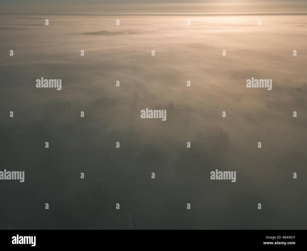 drone image. aerial view of rural area with sun halo above mist. high ...