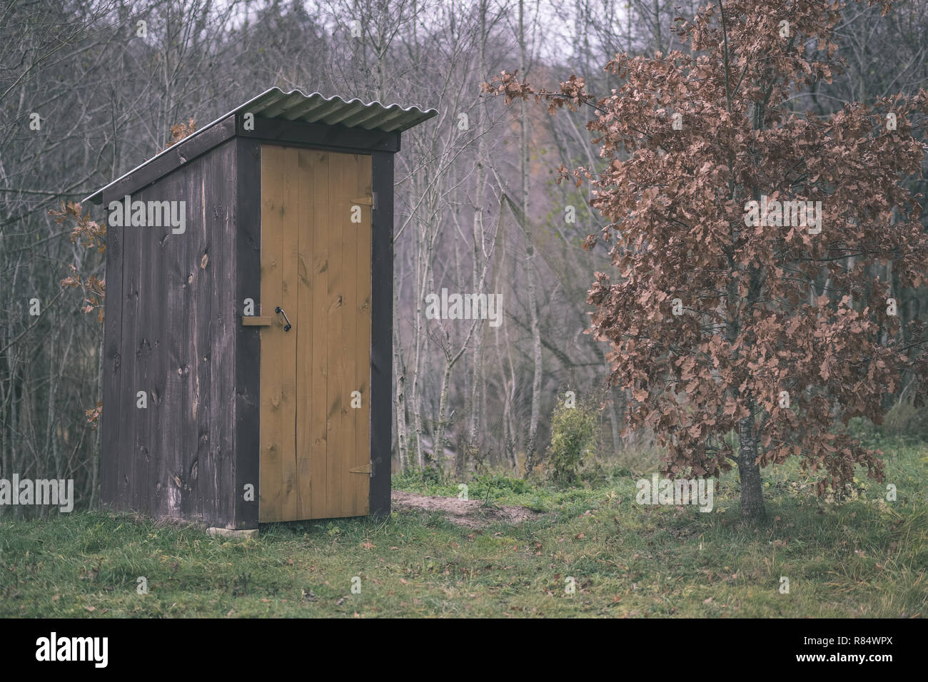 old wooden countryside toilet house with heart shaped hole in the door ...