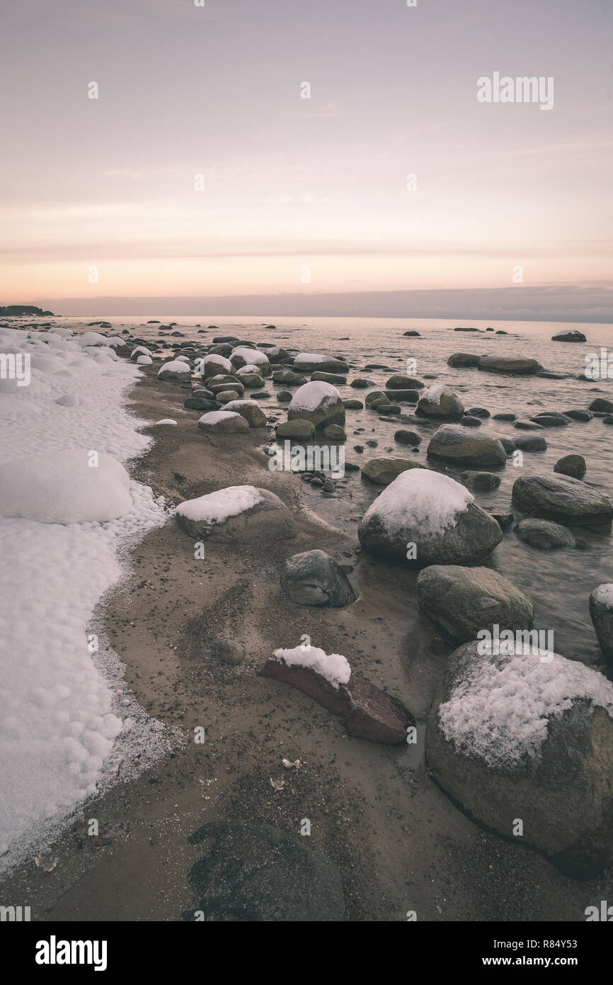 frozen sea side beach panorama in winter with lots of ice and snow in ...
