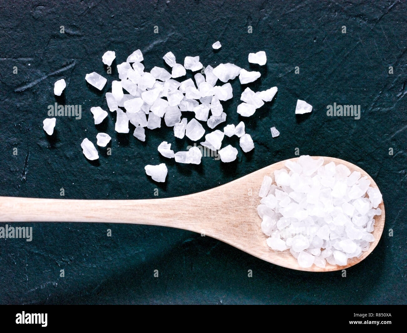 coarse sea salt on dark background close up. Copy space. Flat lay or ...