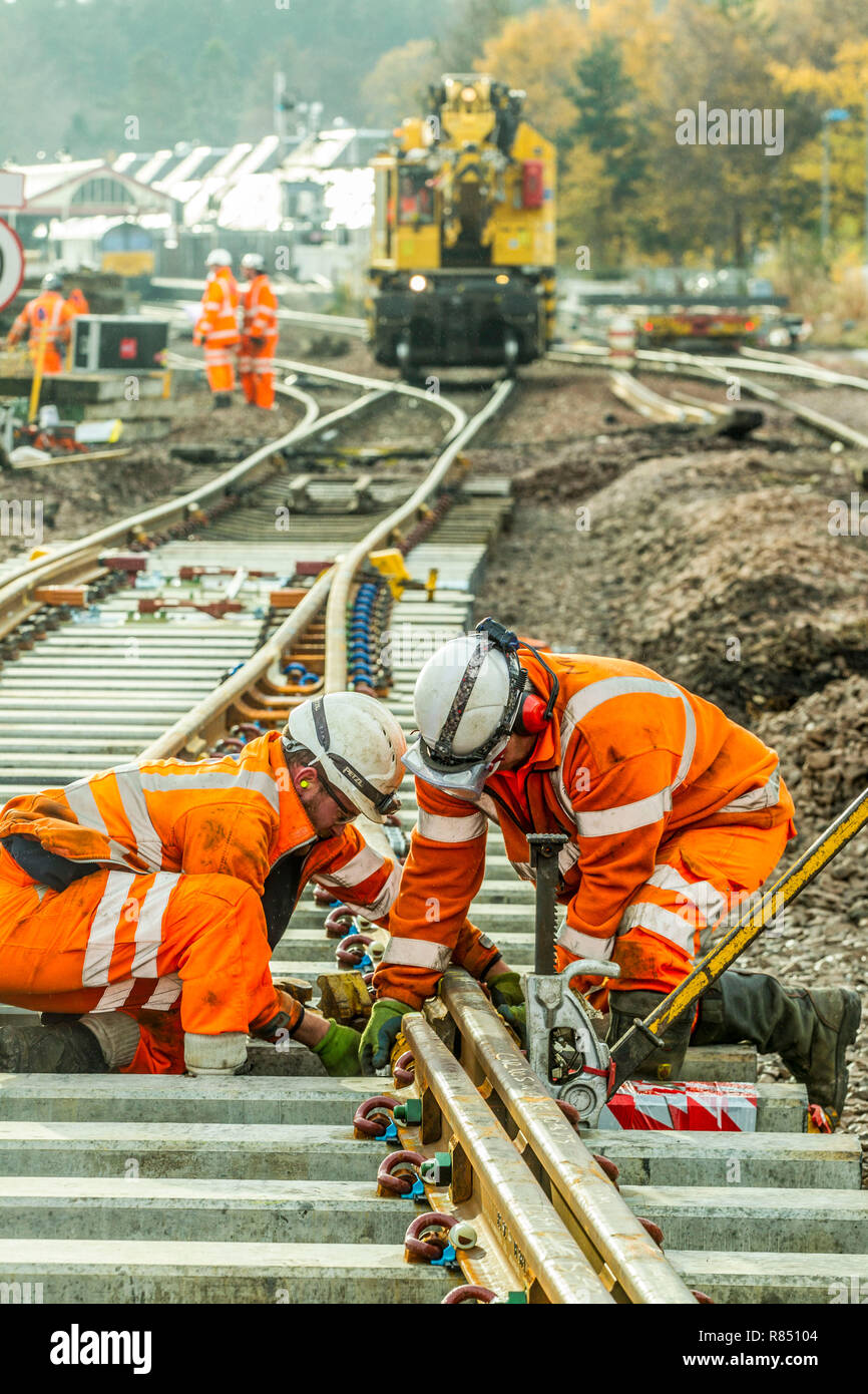 Rail workers laying new track, balls, installing points and laying ...