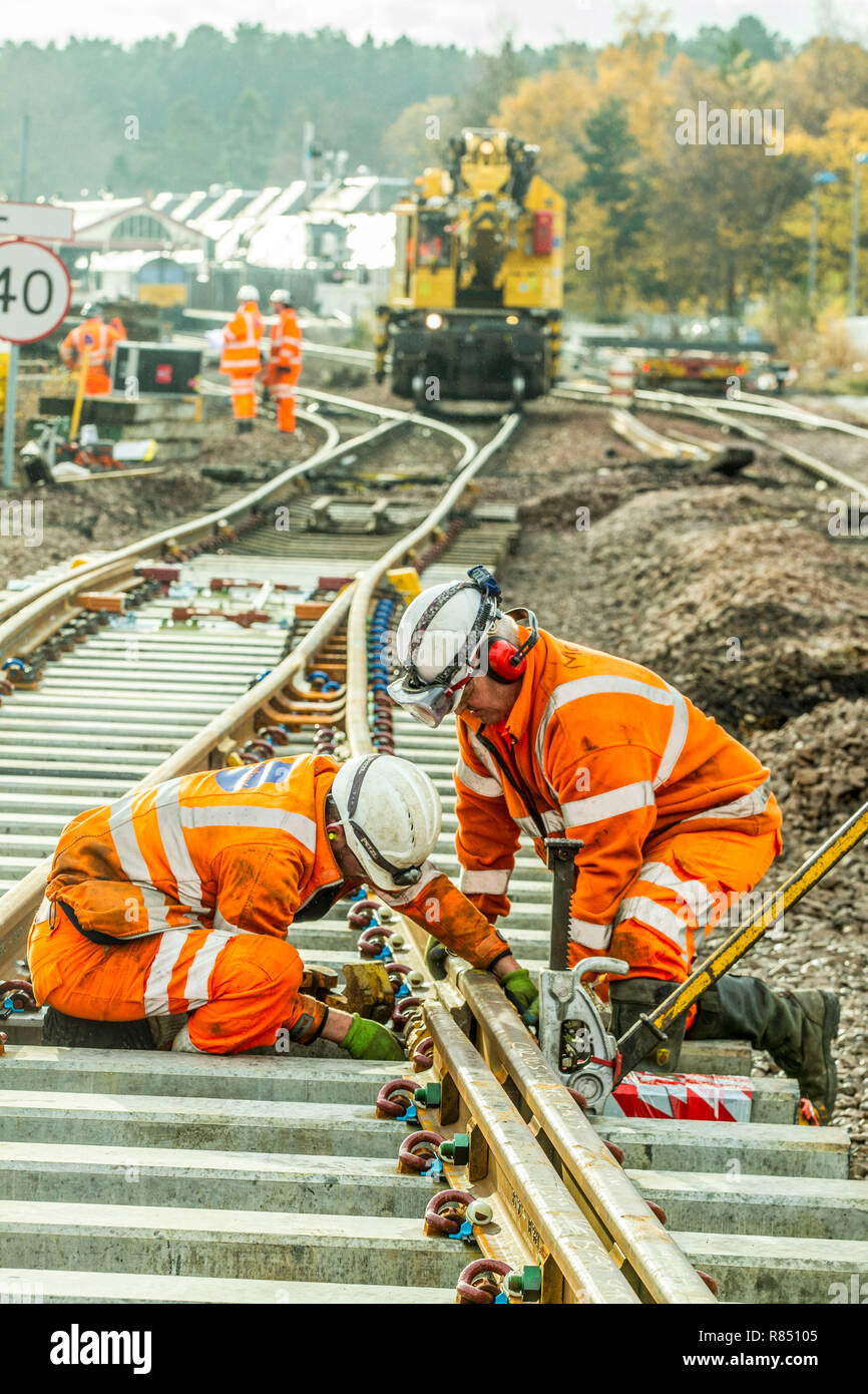 Rail workers laying new track, balls, installing points and laying ...