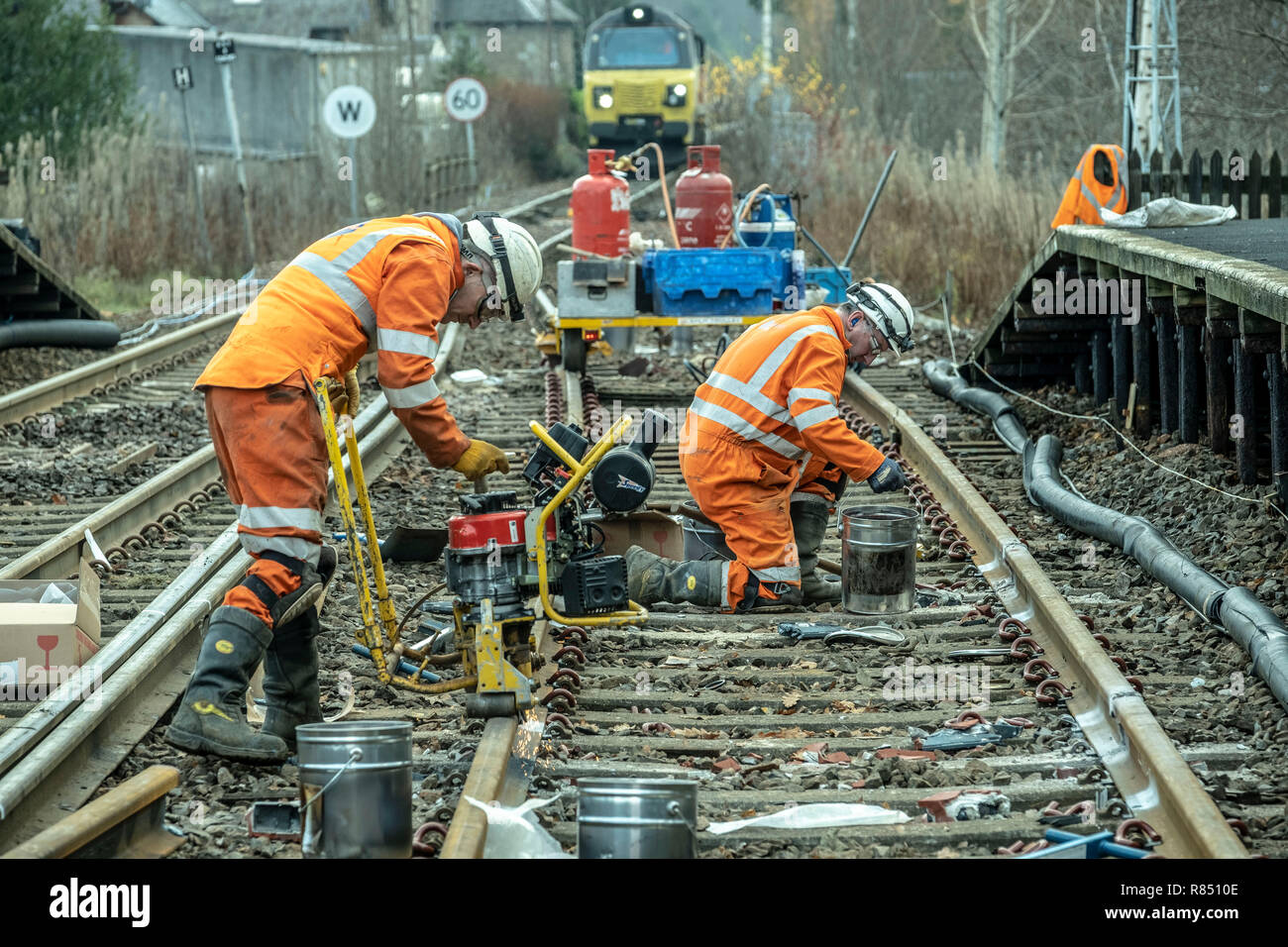 Rail workers laying new track, balls, installing points and laying ...