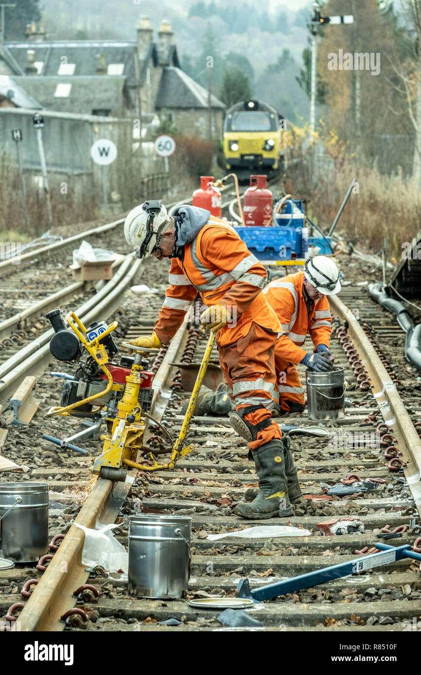Rail workers laying new track, balls, installing points and laying ...