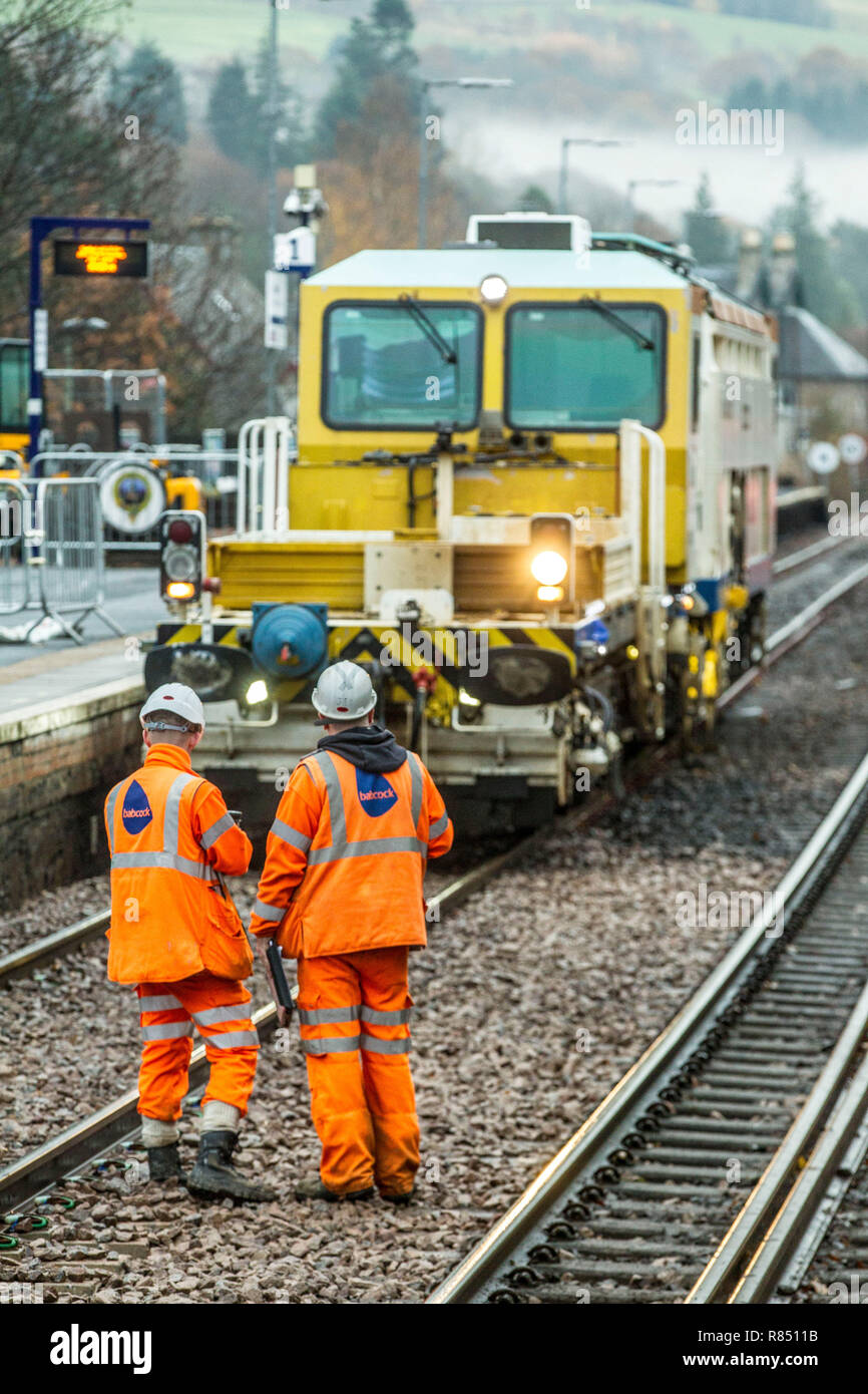 Rail workers laying new track, balls, installing points and laying ...