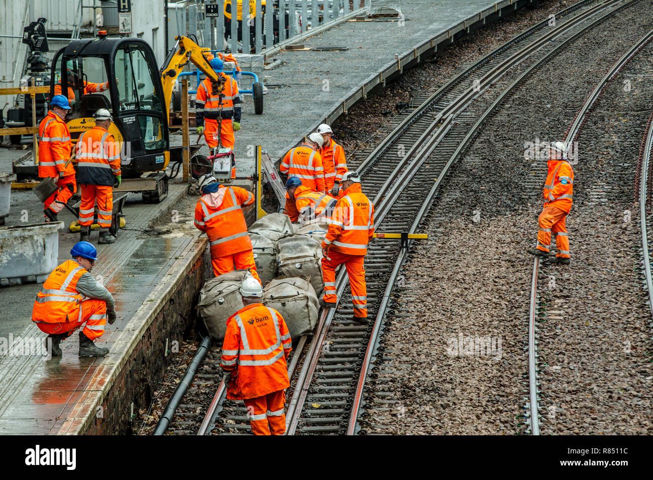 Rail workers laying new track, balls, installing points and laying ...