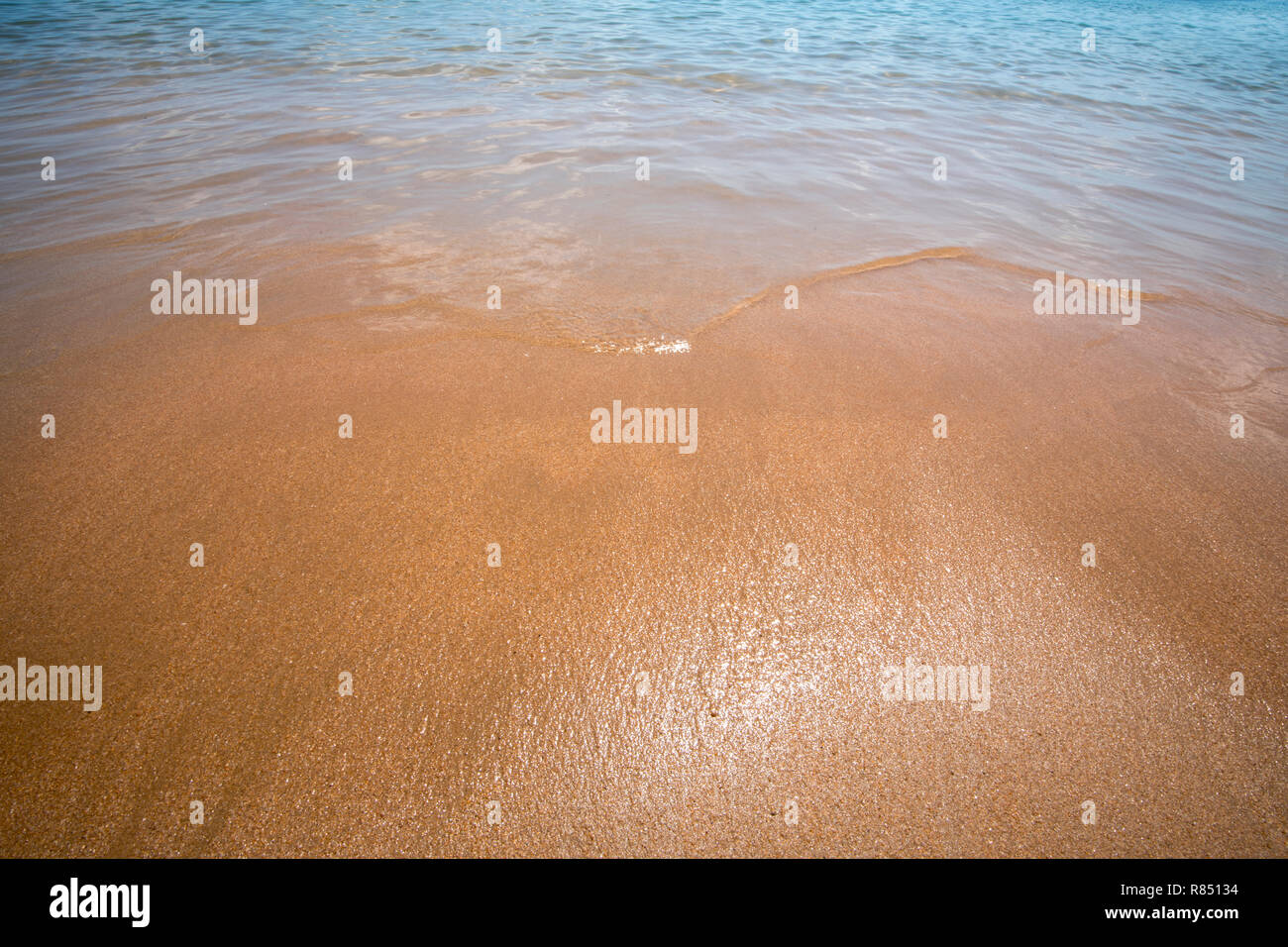 Sand beach with waves blue,background nature ocean Stock Photo - Alamy