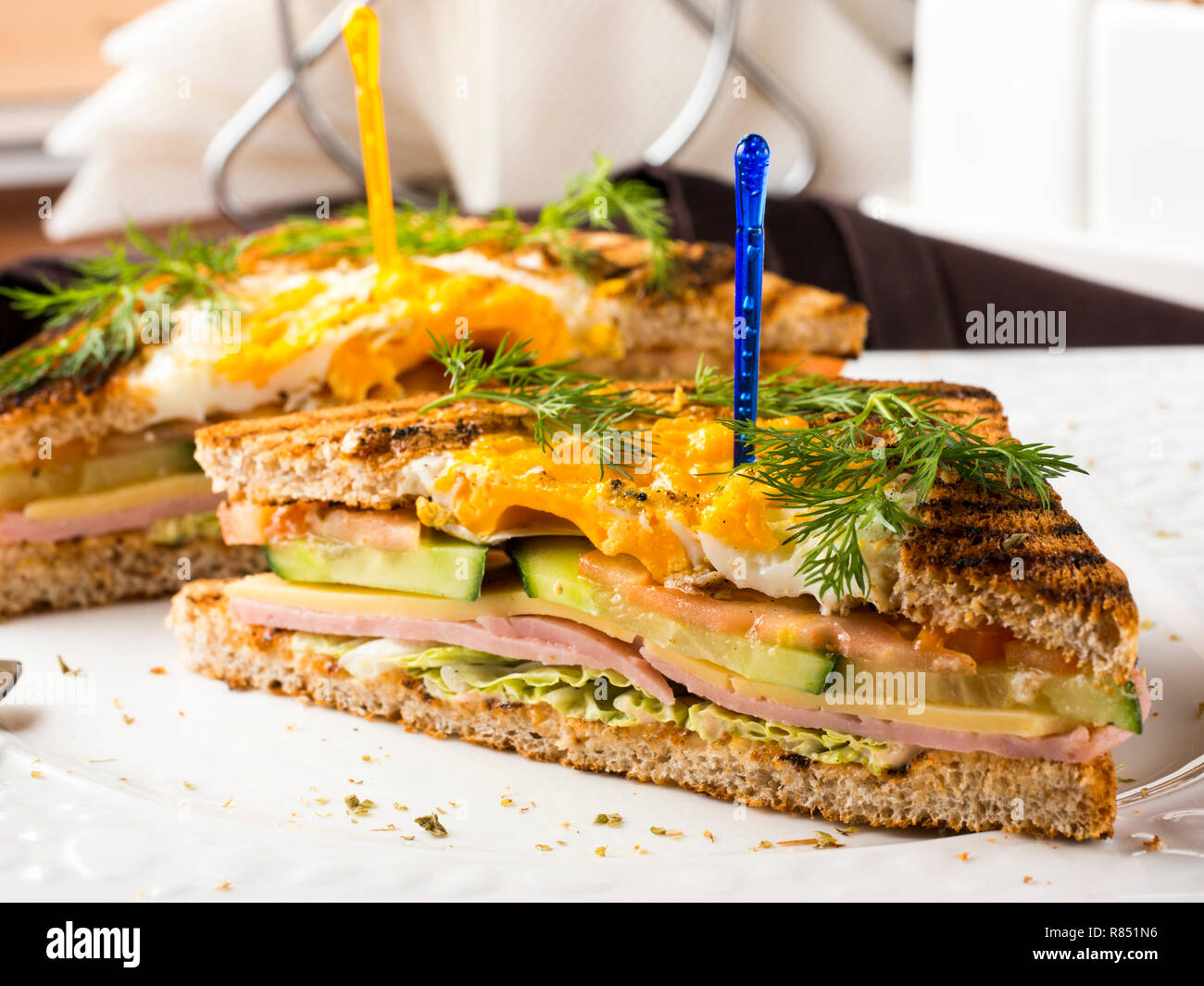 Club sandwich with egg, cucumber, tomato, ham. Two club sandwiches on ...