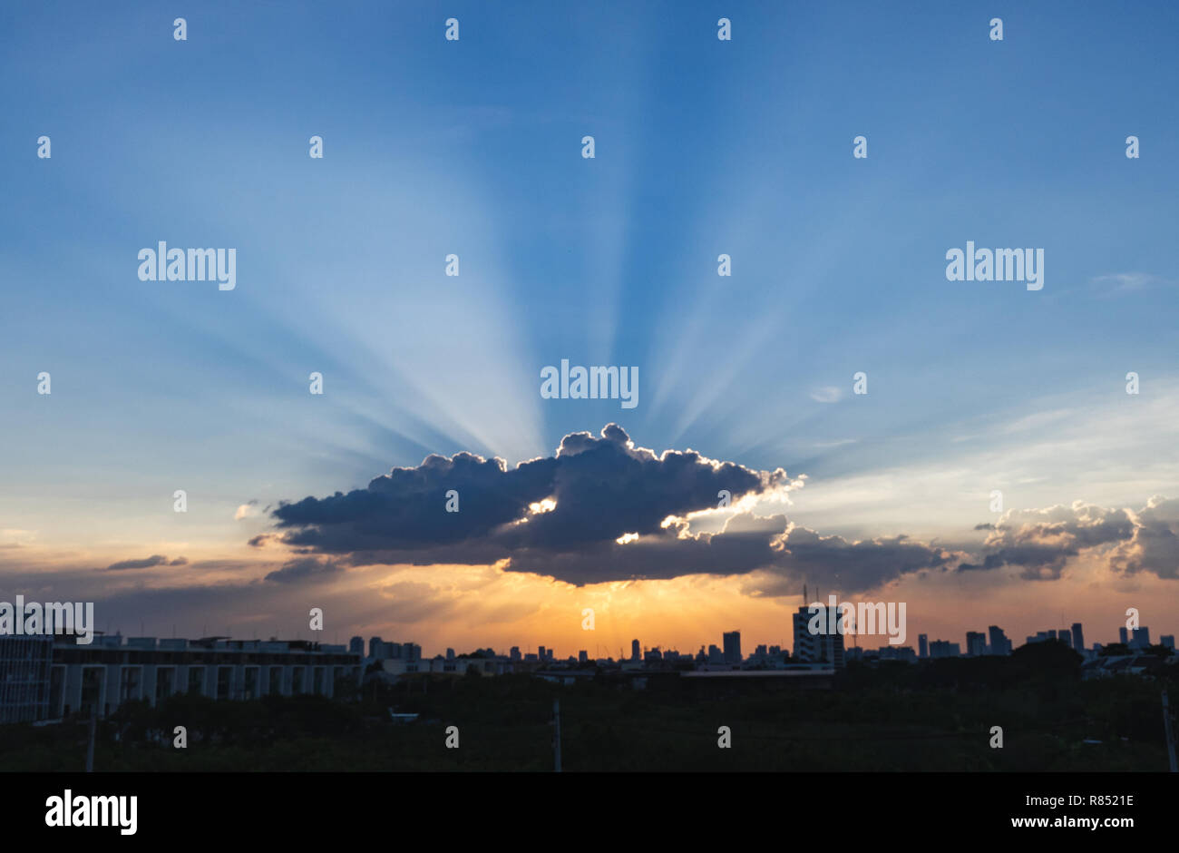 Sunbeam through the dramatic cloud during sunset time, with silhouette ...