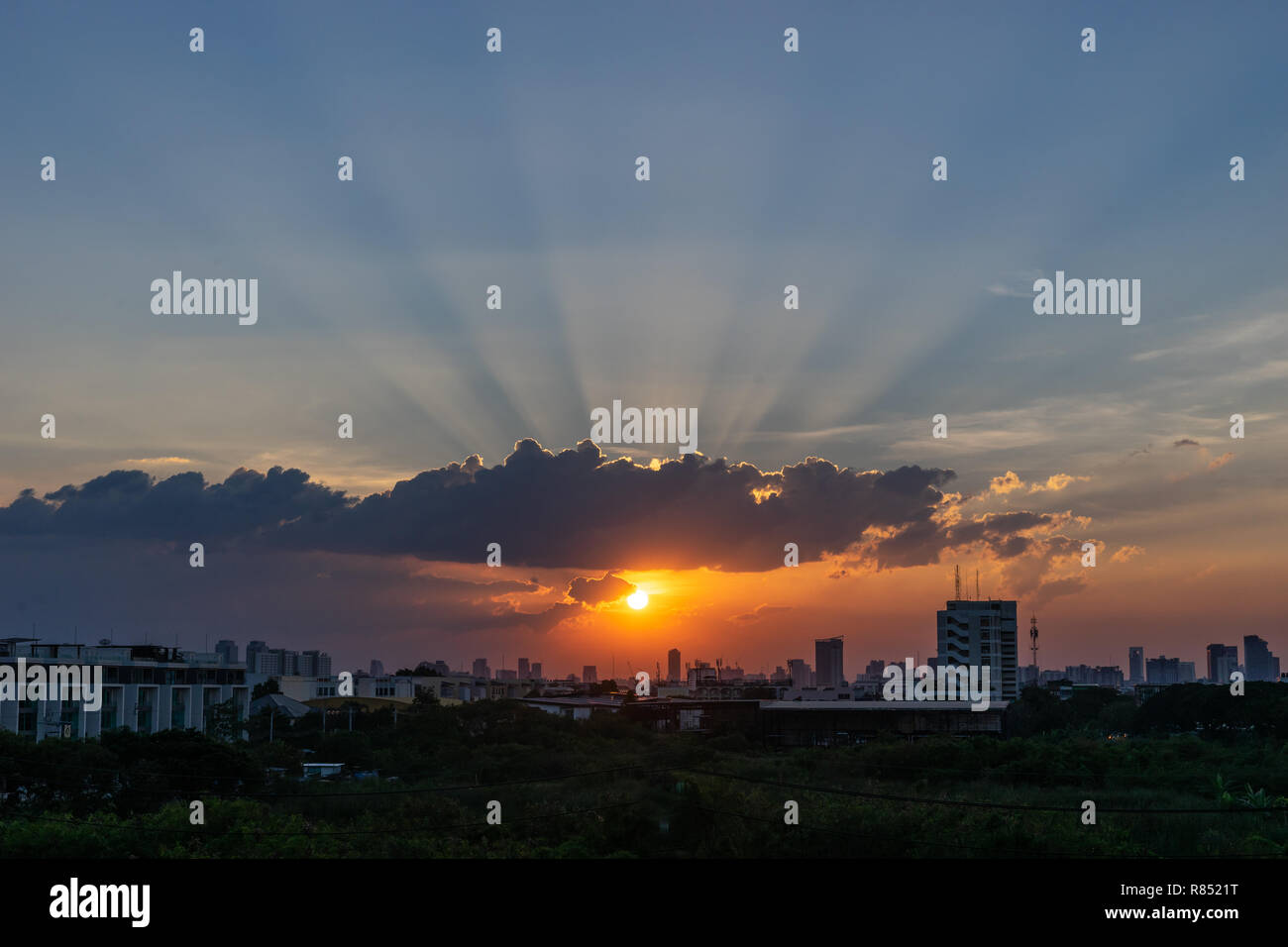 Sunbeam through the dramatic cloud during sunset time, with silhouette ...