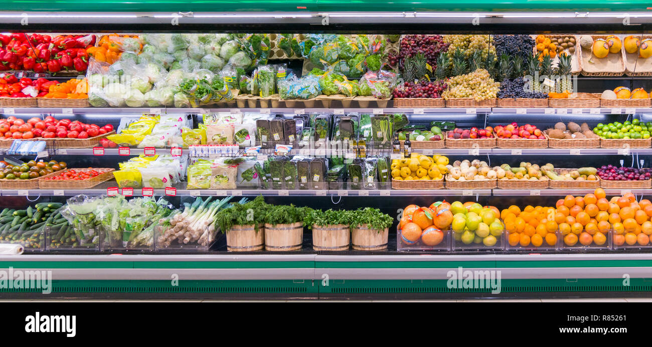 Fresh fruits and vegetables on shelf in supermarket. For healthy ...