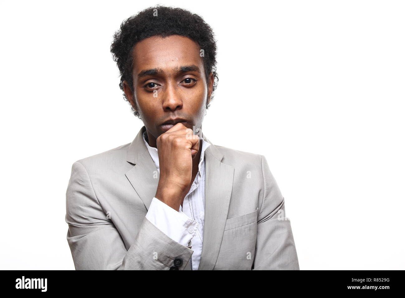 Portrait of a beautiful African man in front of a white background ...