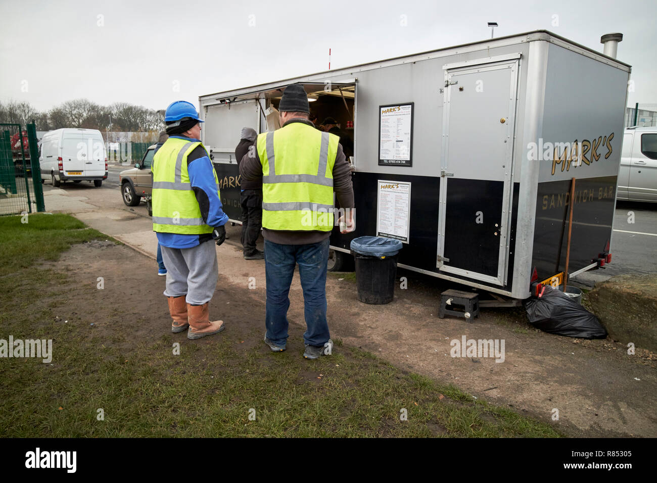 workmen queue outside roadside cafe on an industrial estate merseyside ...