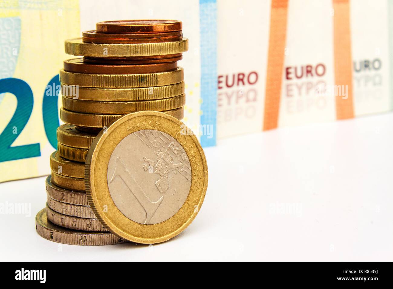 Euro coins and banknotes on a white background. Exchange rate. Stock ...