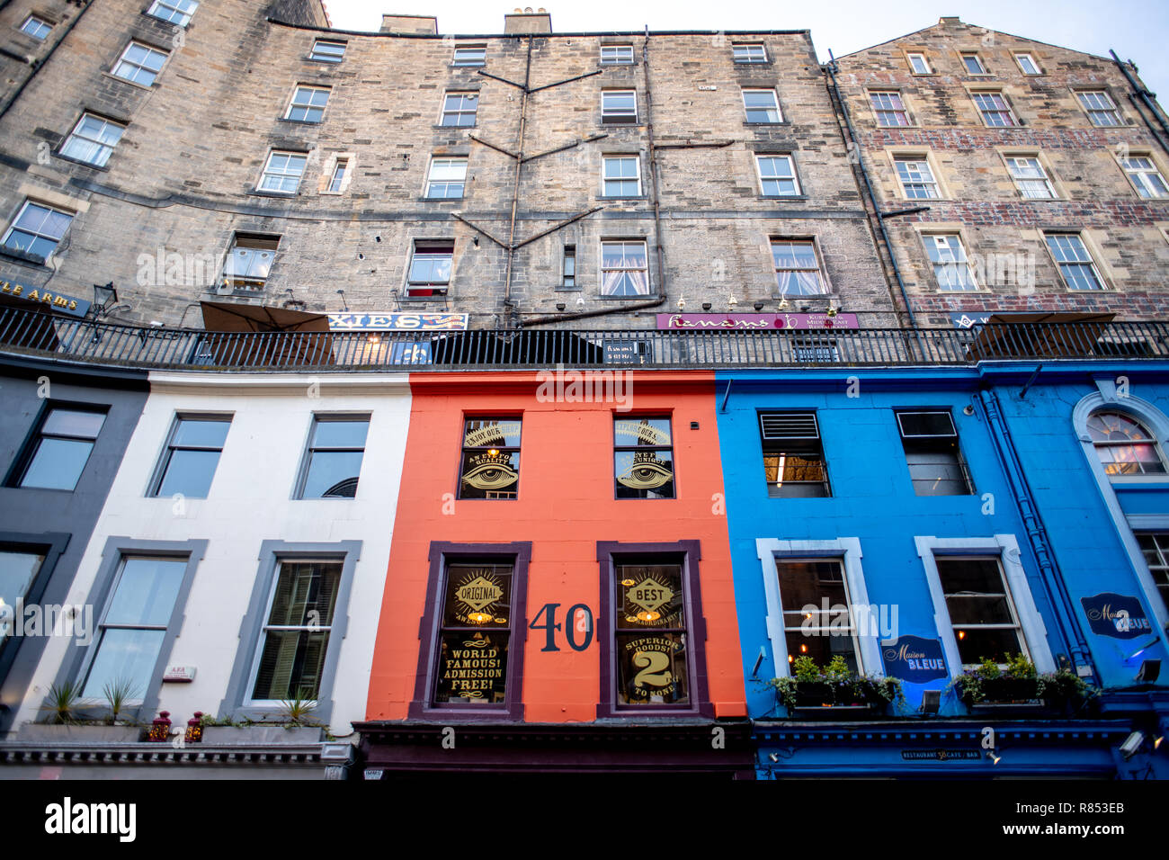 Pastel colored store fronts line a street in Edinburgh, Scotland, UK ...