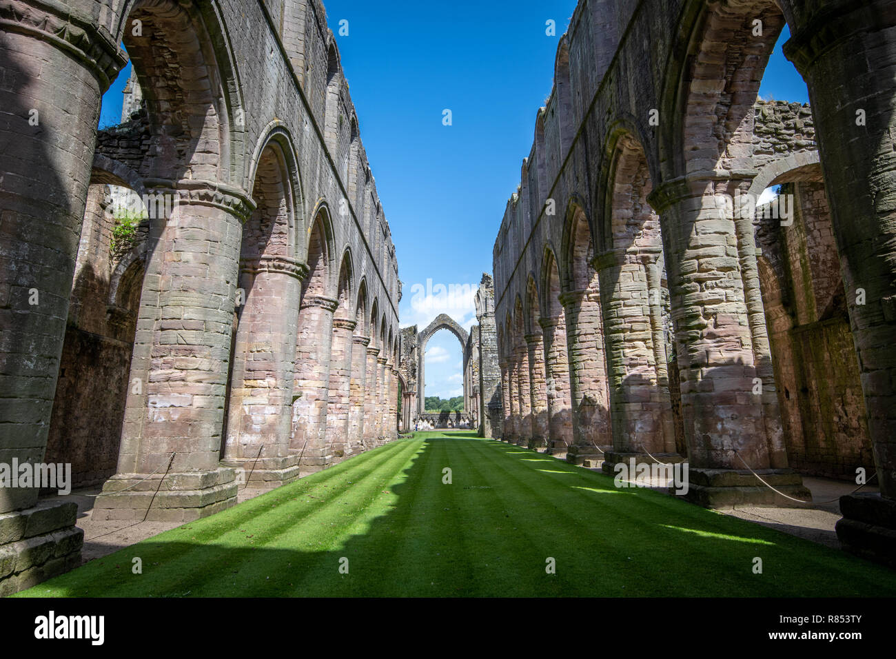 The massive empty framework of the Fountains Abbey is some of the only ...