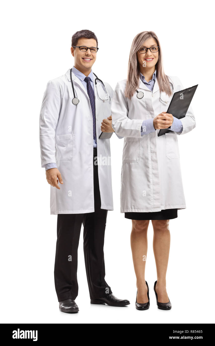 Full length portrait of a male and female doctor smiling at the camera ...